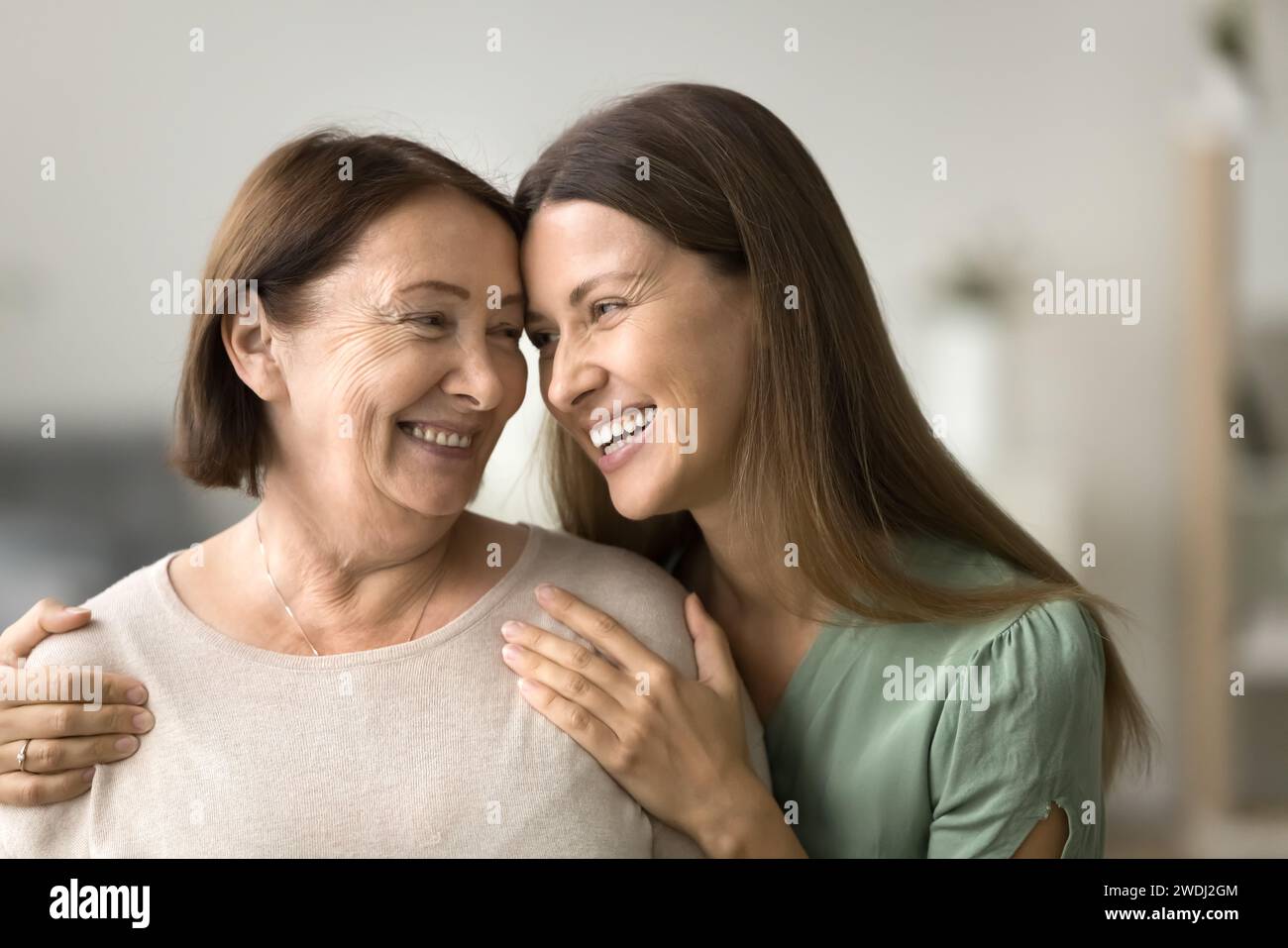 Happy adult daughter woman hugging elder mature mom from behind Stock ...
