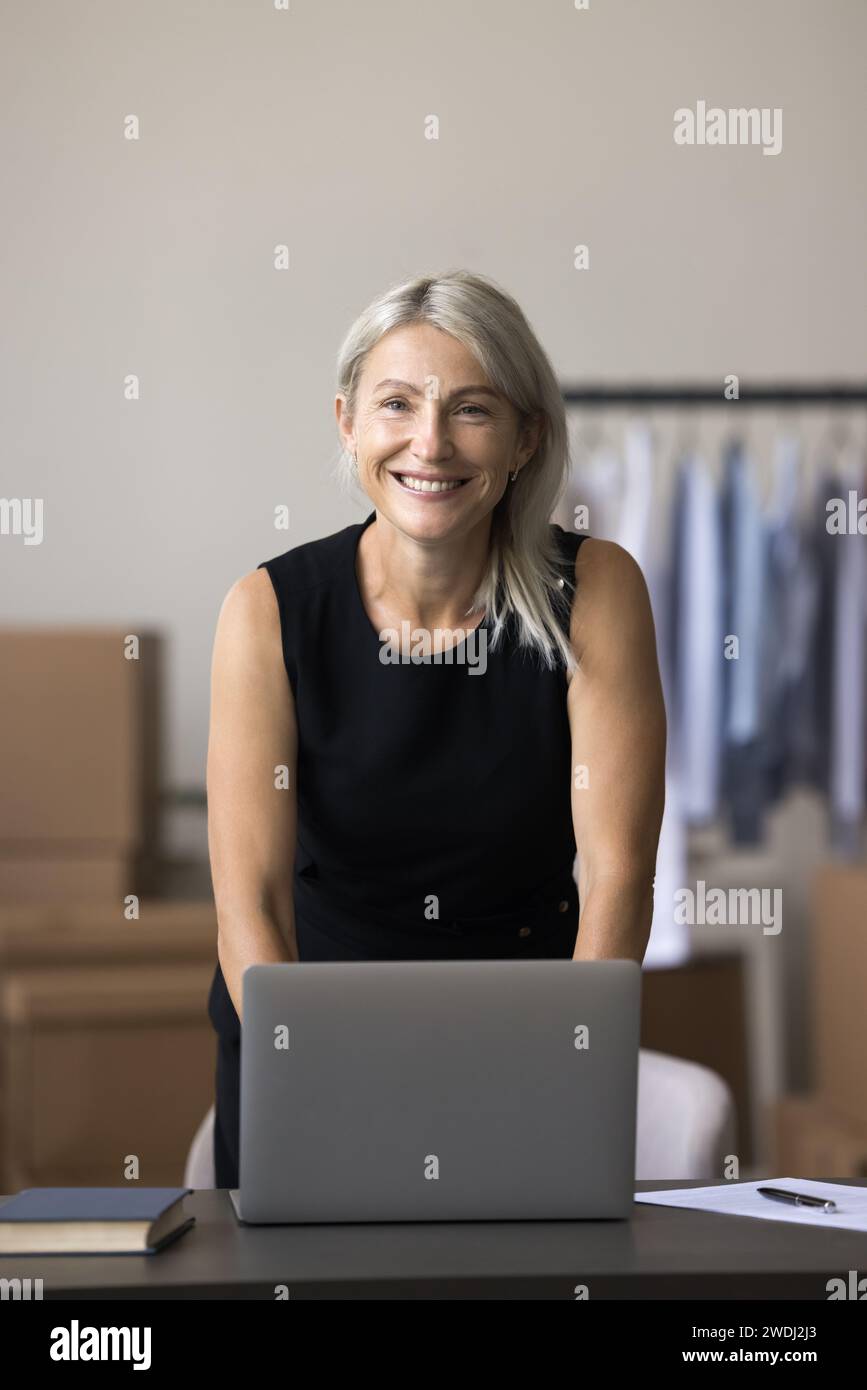 Portrait of middle-aged small business owner posing in warehouse Stock ...