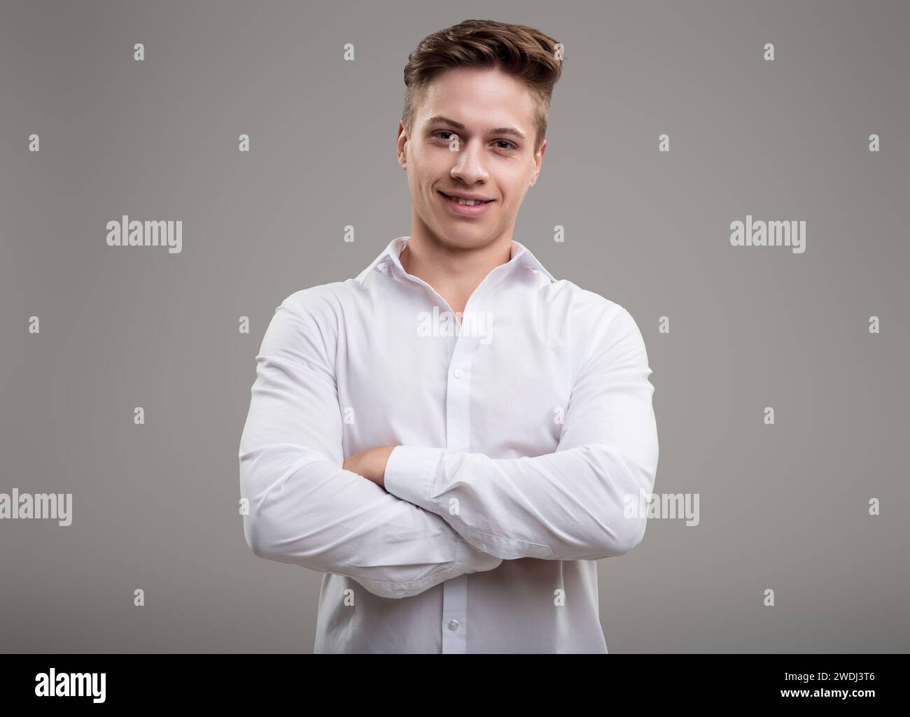 White shirted man, confident, arms crossed, approachableWhite shirted ...