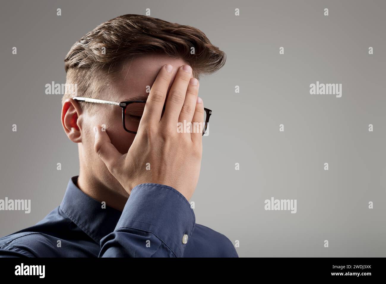 Face covered, forgotten embarrassment disrupts composed exterior Stock ...