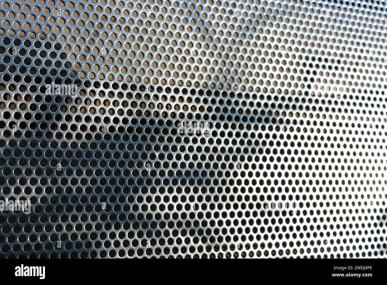 Metal mesh, background, with round identical holes, metal structure ...