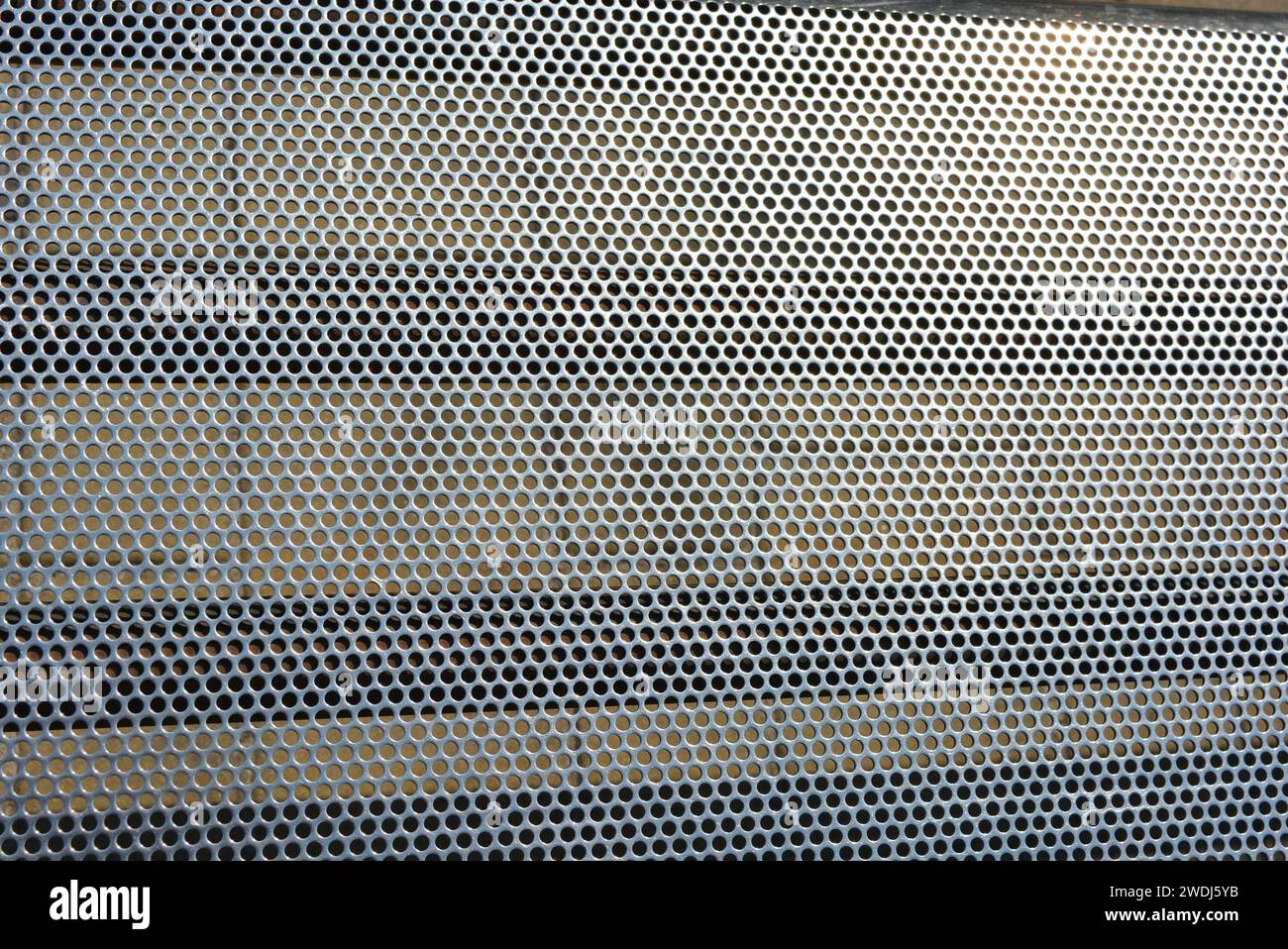 Metal mesh, background, with round identical holes, metal structure ...
