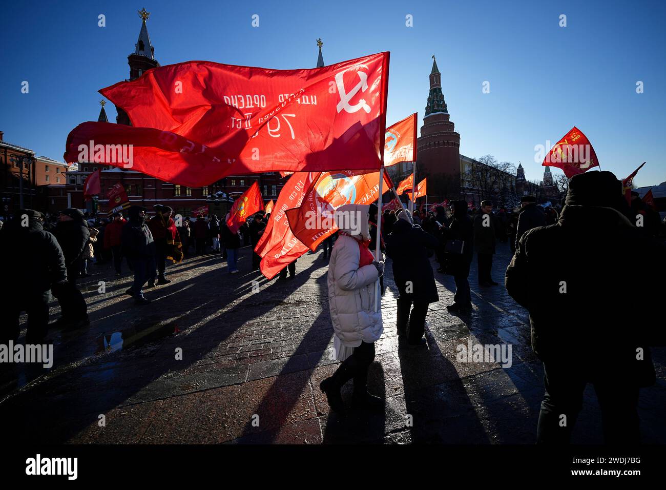 Russian Communist supporters carry red flags as they walk to lay ...