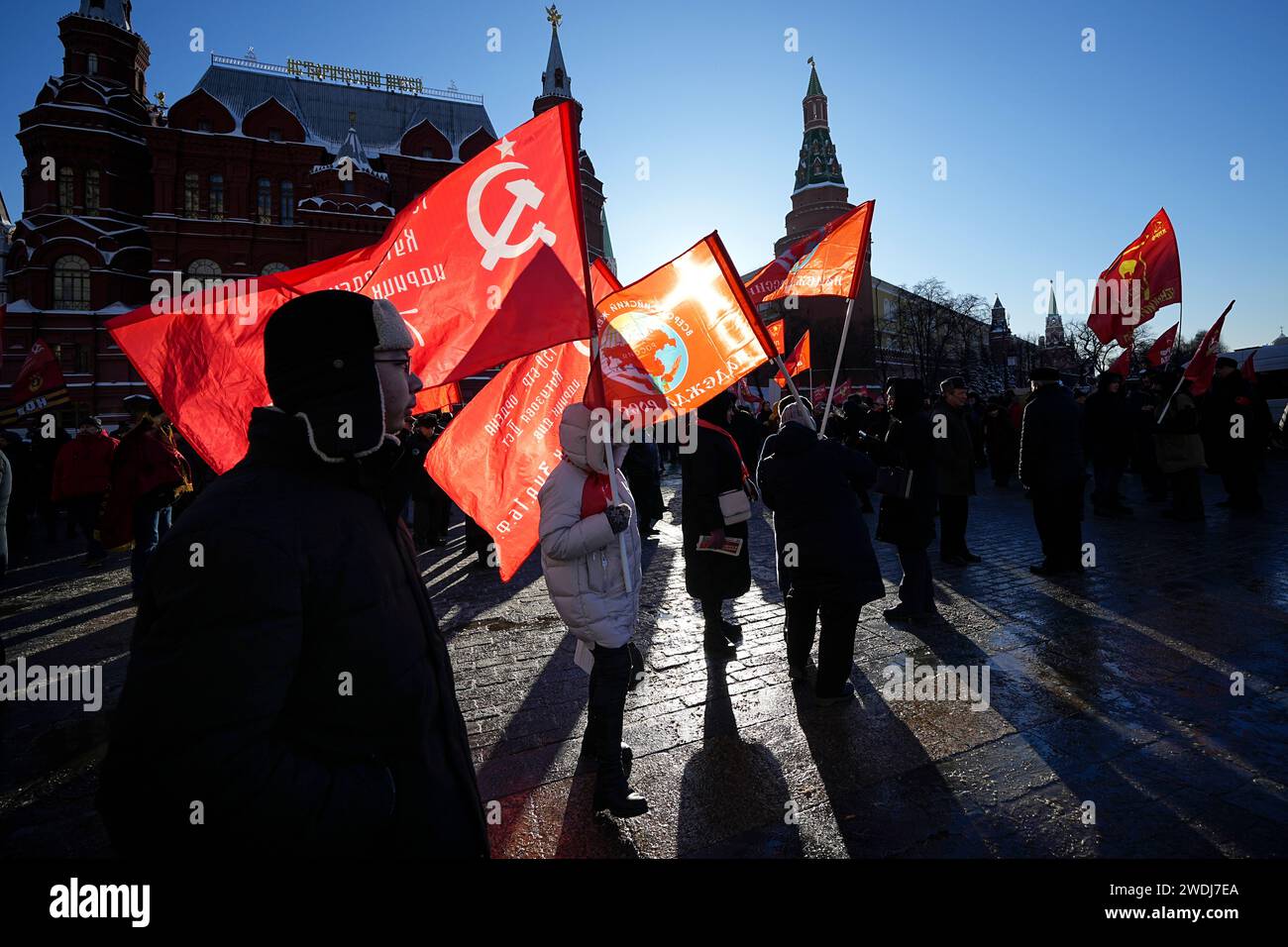 Russian Communist supporters carry red flags as they walk to lay ...