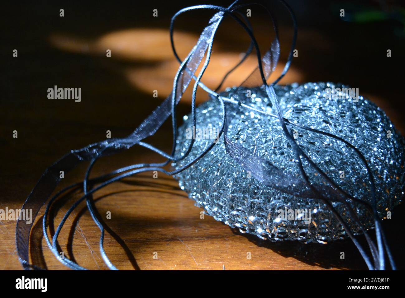 Metal sponge with a transparent black ribbon and black threads on a ...