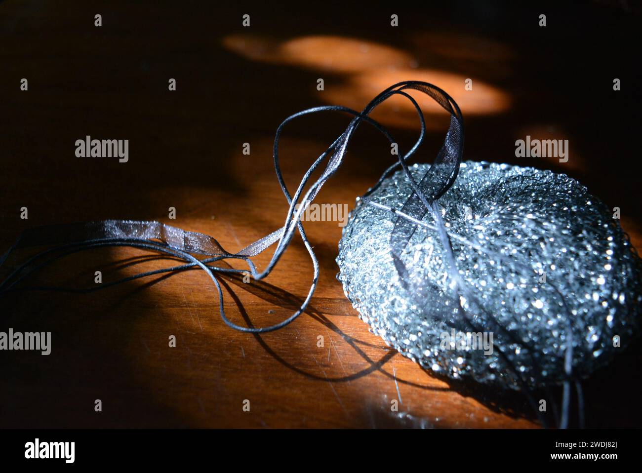 Metal sponge with a transparent black ribbon and black threads on a ...