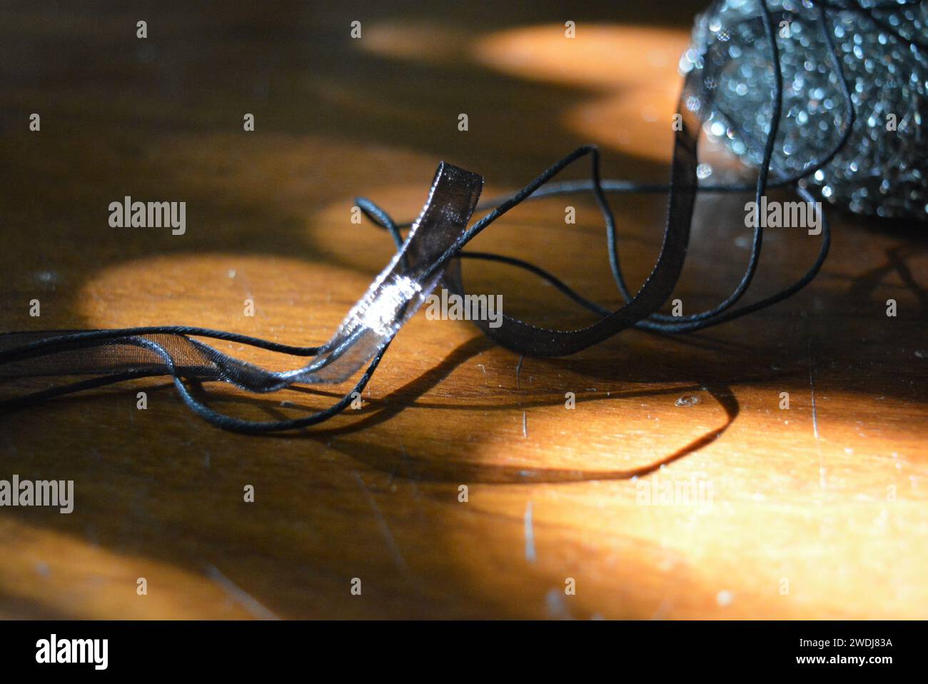 Metal sponge with a transparent black ribbon and black threads on a ...