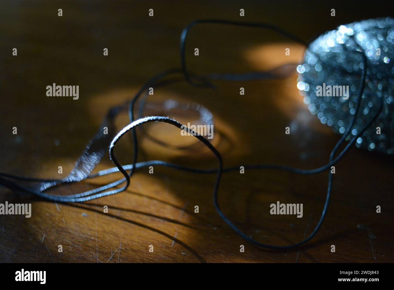 Metal sponge with a transparent black ribbon and black threads on a ...
