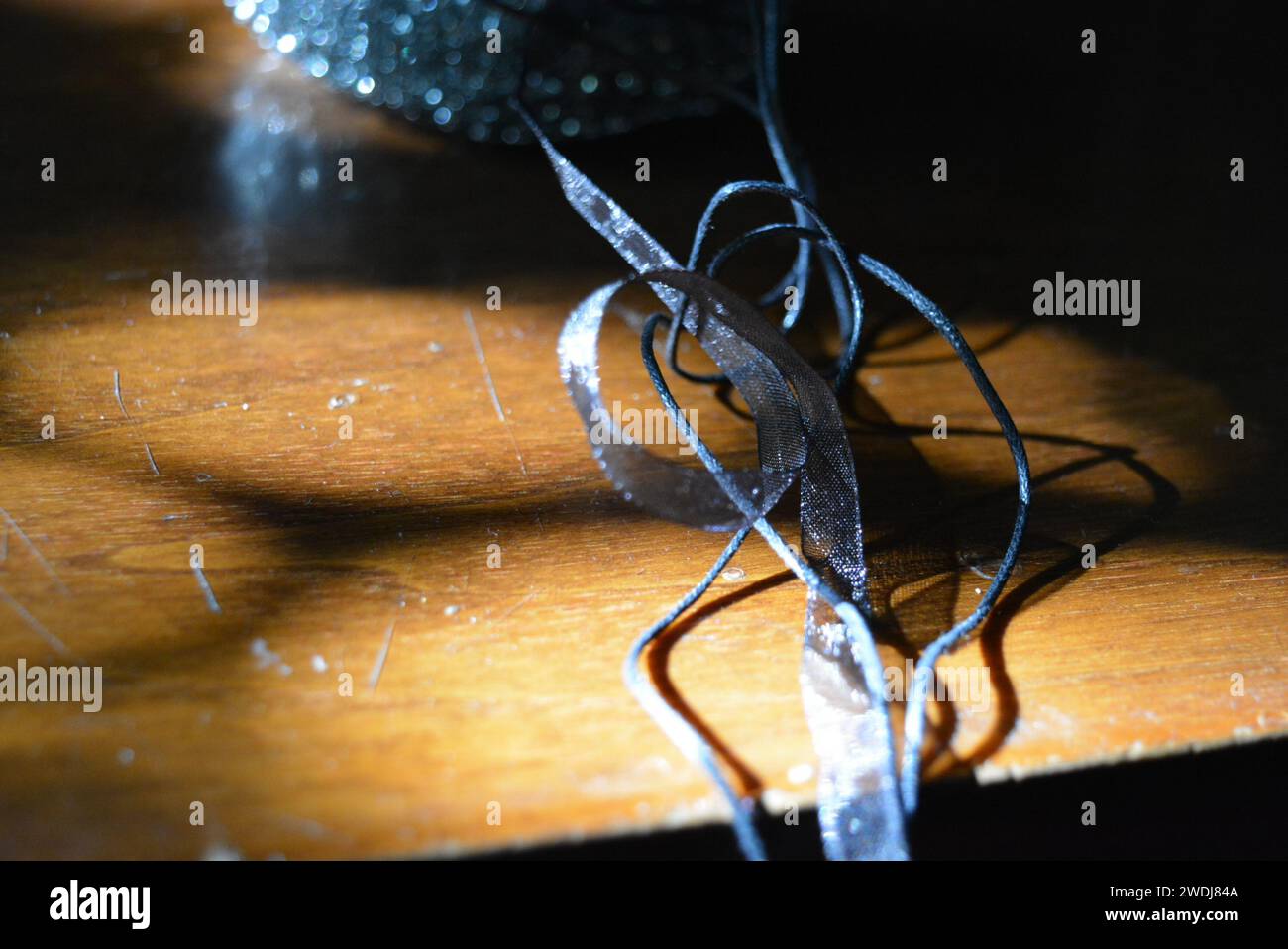 Metal sponge with a transparent black ribbon and black threads on a ...