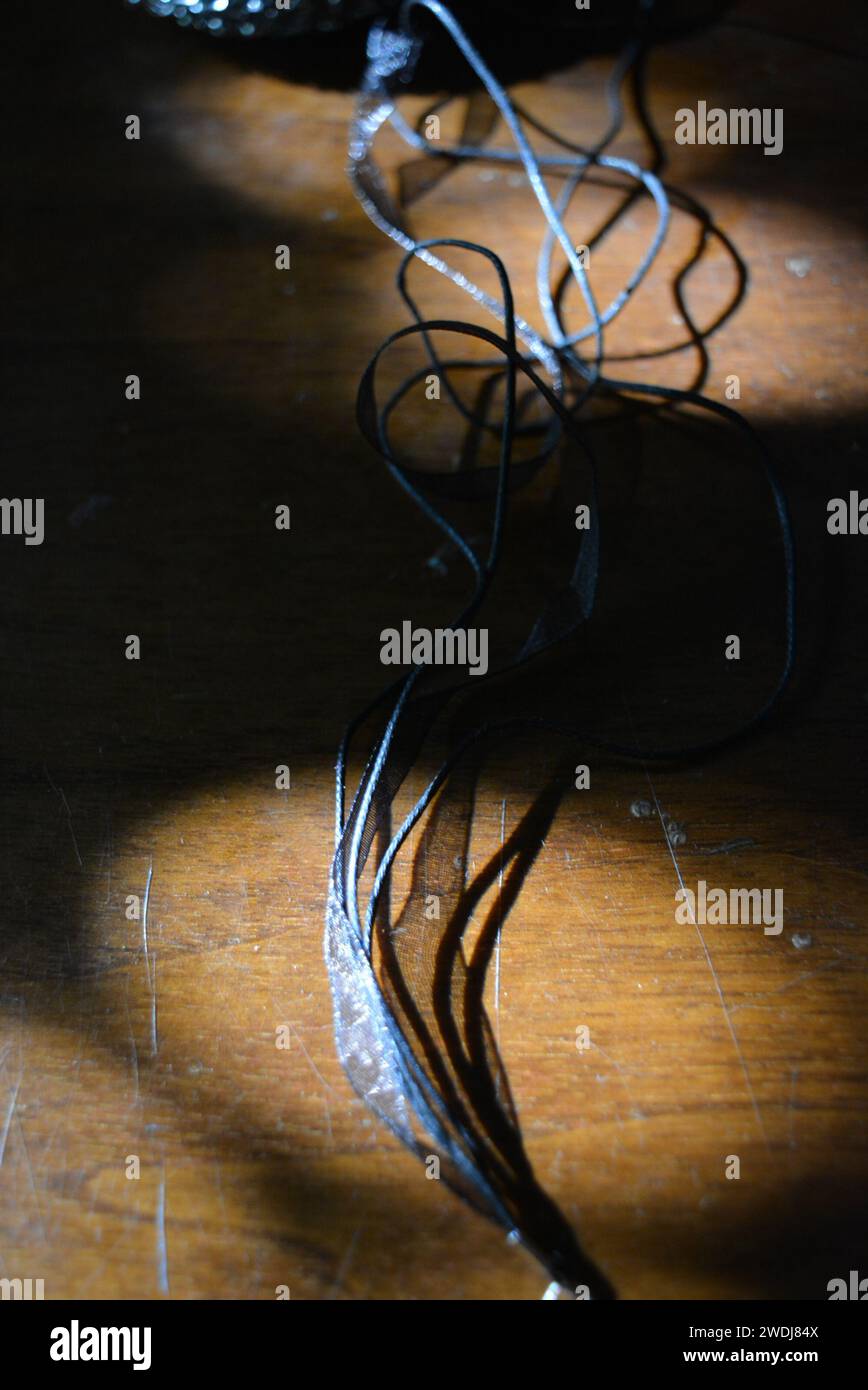 Metal sponge with a transparent black ribbon and black threads on a ...