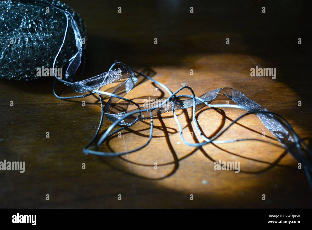 Metal sponge with a transparent black ribbon and black threads on a ...