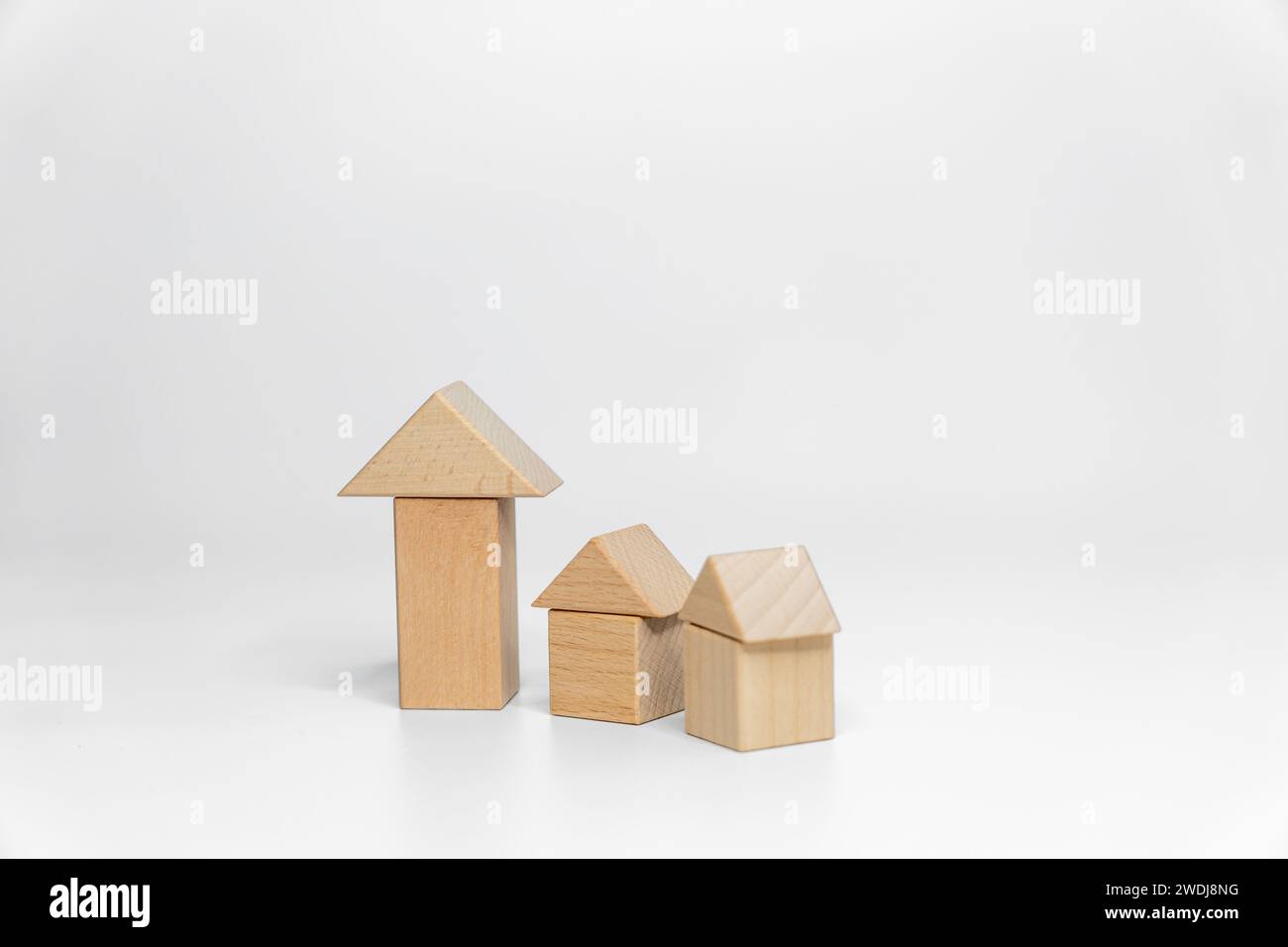 building wood blocks on white background; business or creative concept ...