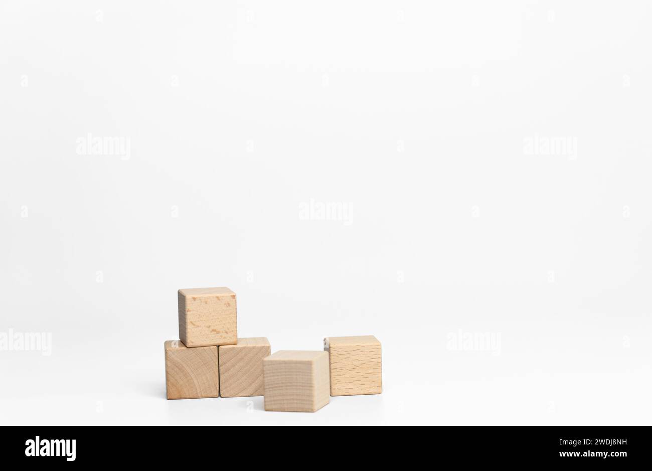 building wood blocks on white background; business or creative concept ...