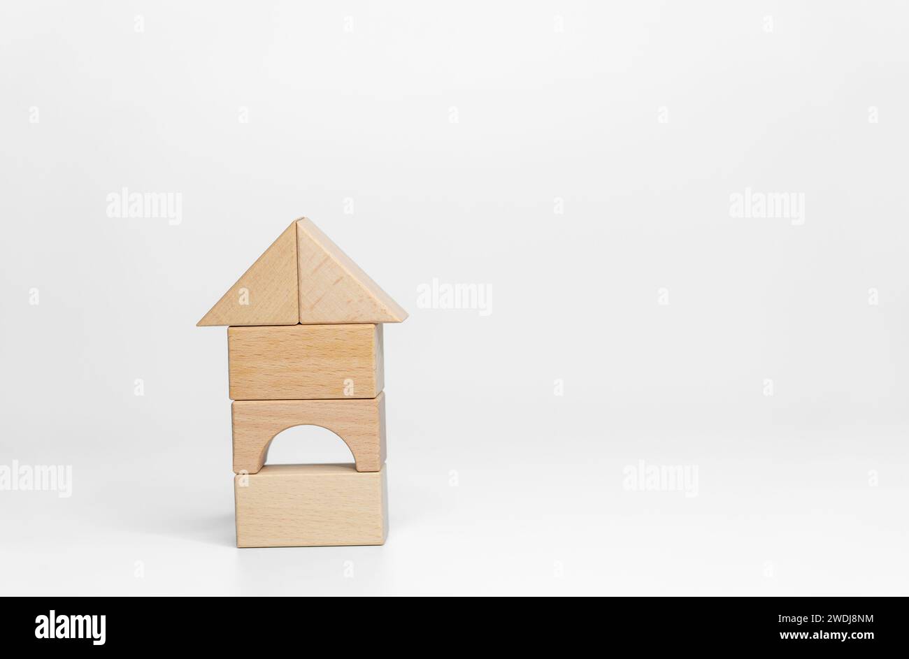 building wood blocks on white background; business or creative concept ...