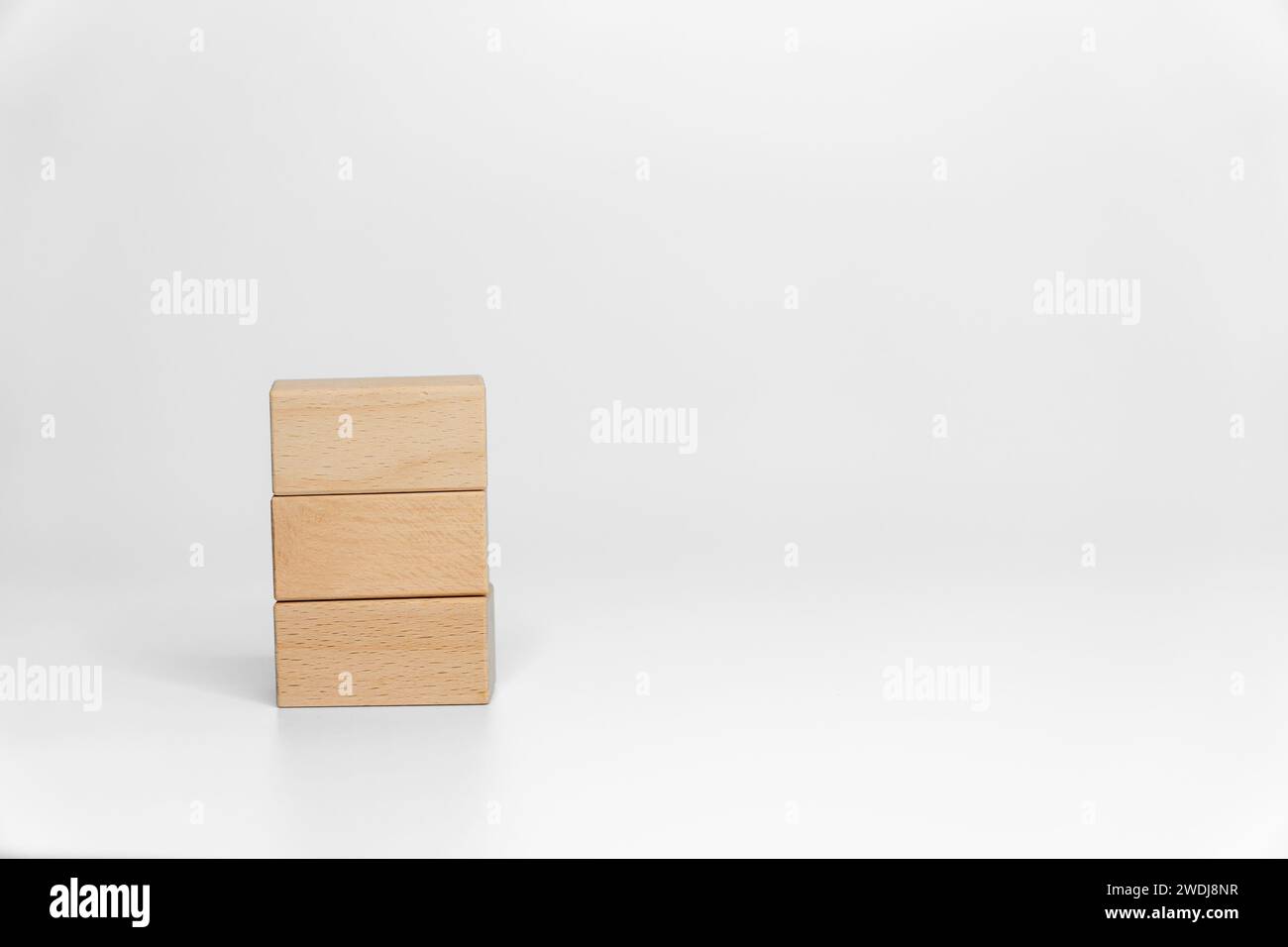 building wood blocks on white background; business or creative concept ...