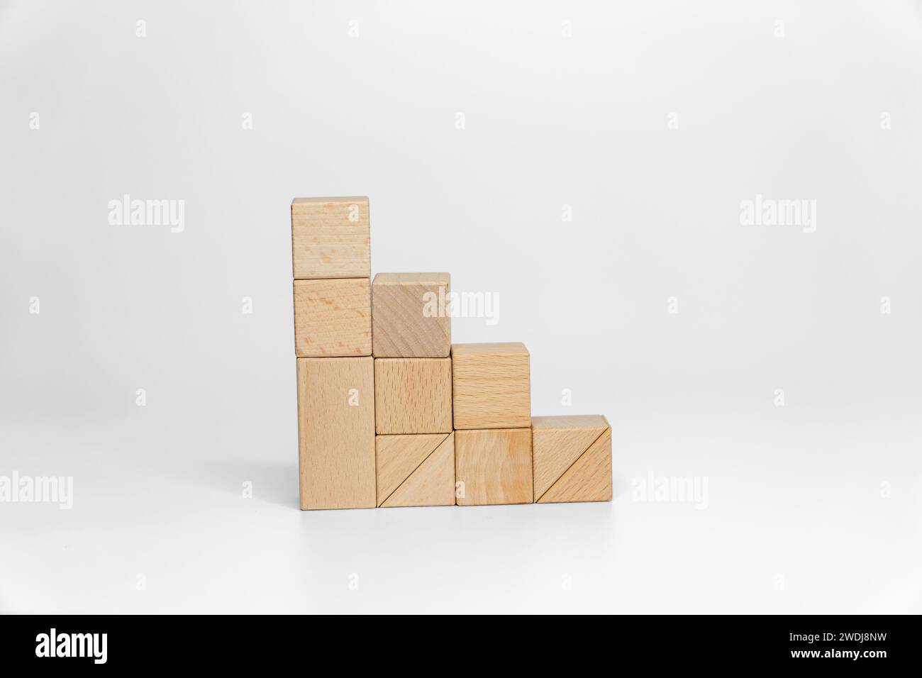 building wood blocks on white background; business or creative concept ...