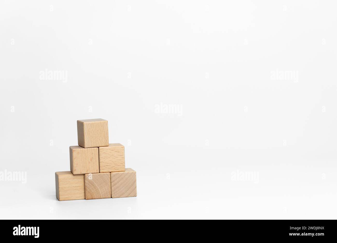 building wood blocks on white background; business or creative concept ...