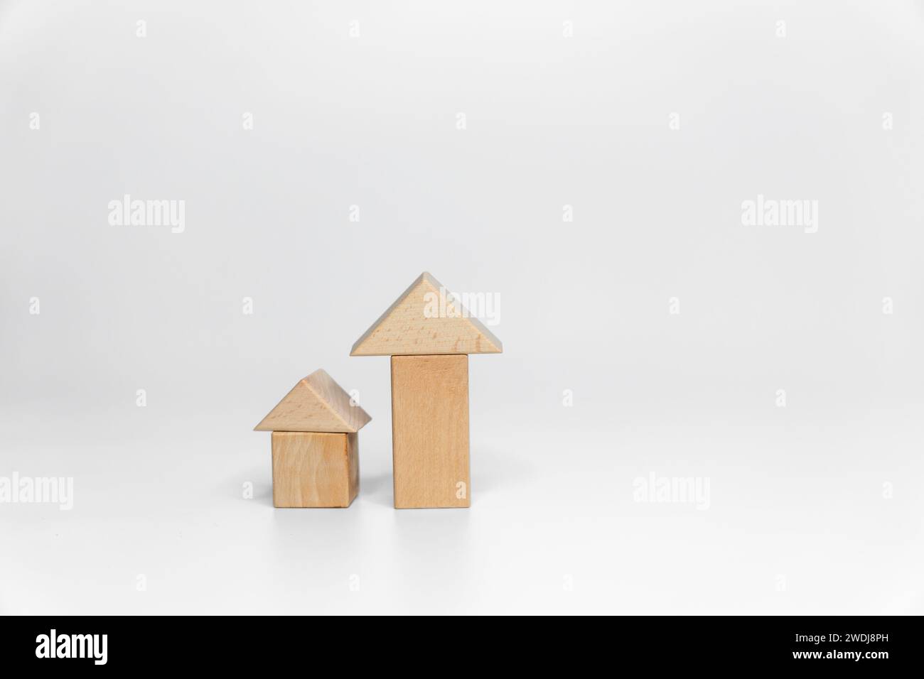 building wood blocks on white background; business or creative concept ...