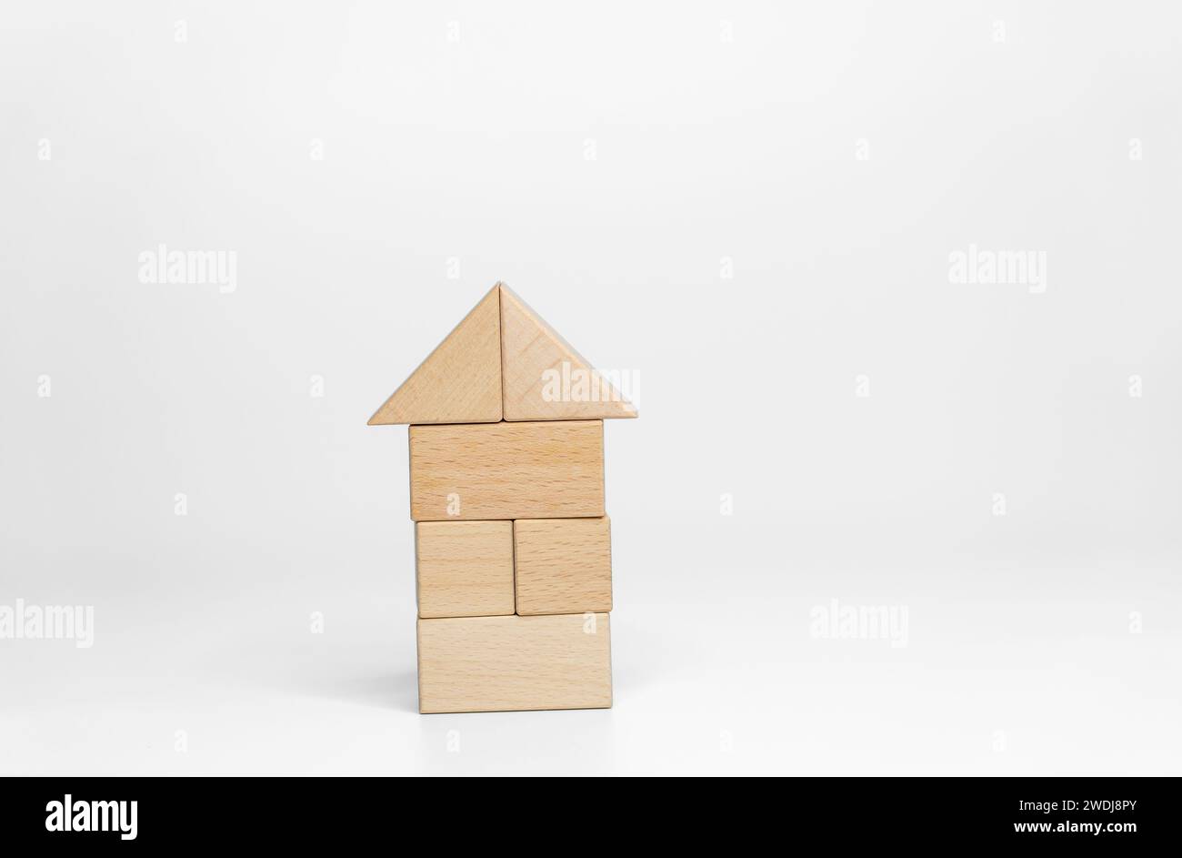 building wood blocks on white background; business or creative concept ...
