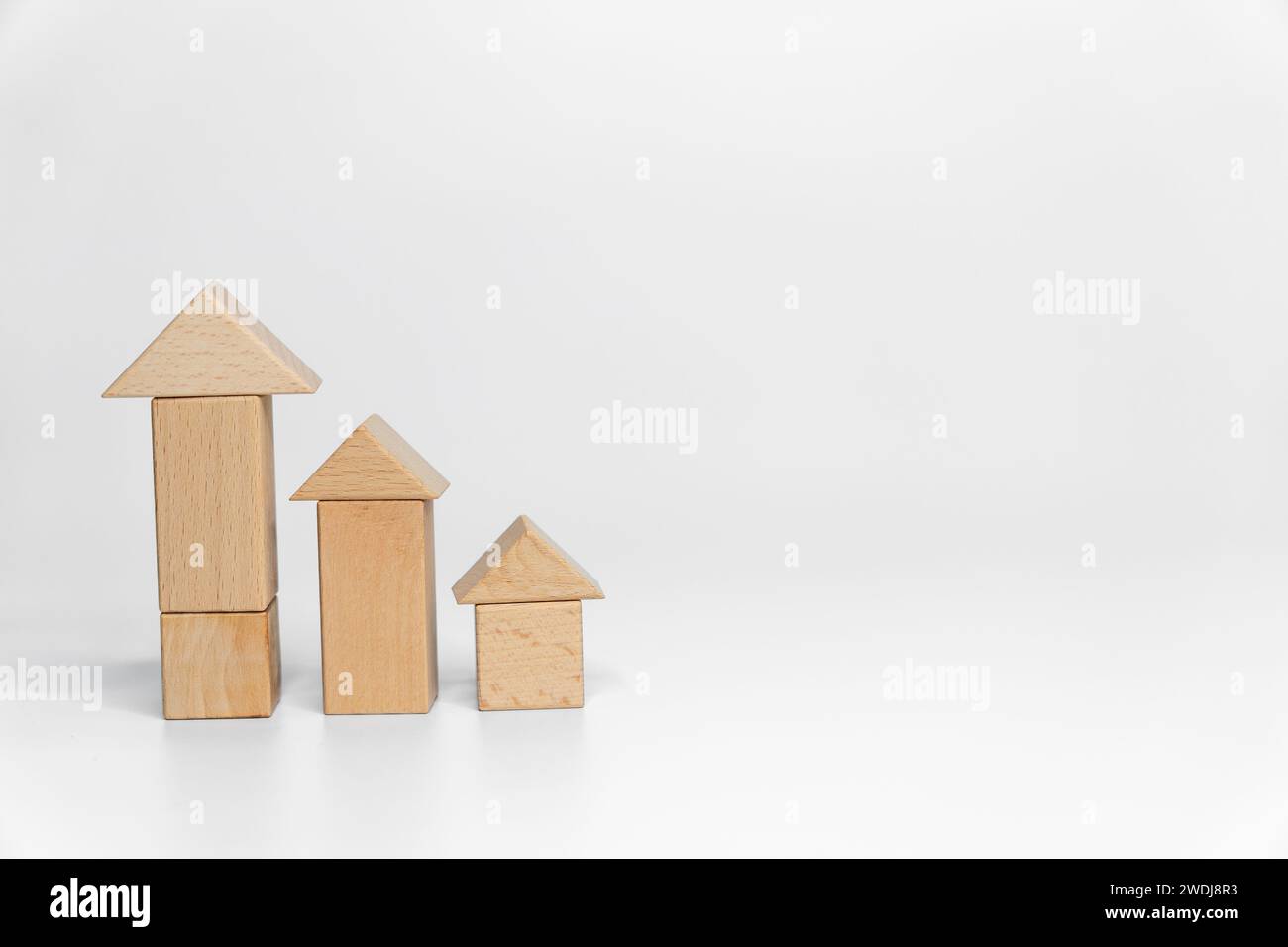 building wood blocks on white background; business or creative concept ...