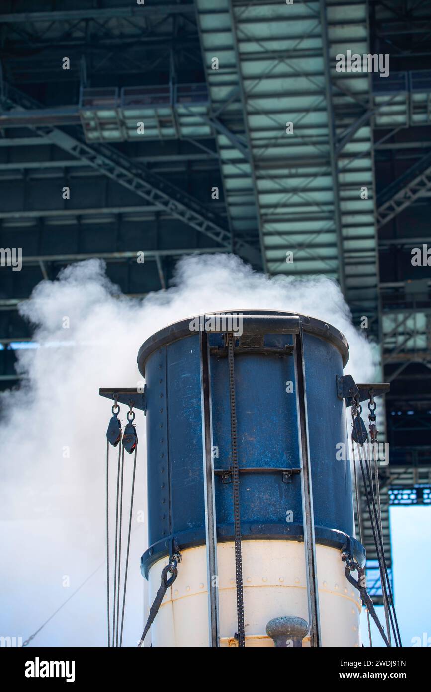 Steam pours from the funnel of the historic 1902 steam tug Waratah ...