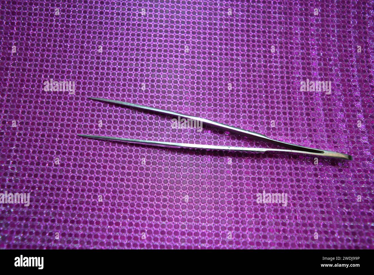 Steel pincer for working on a pink reflective background Stock Photo ...