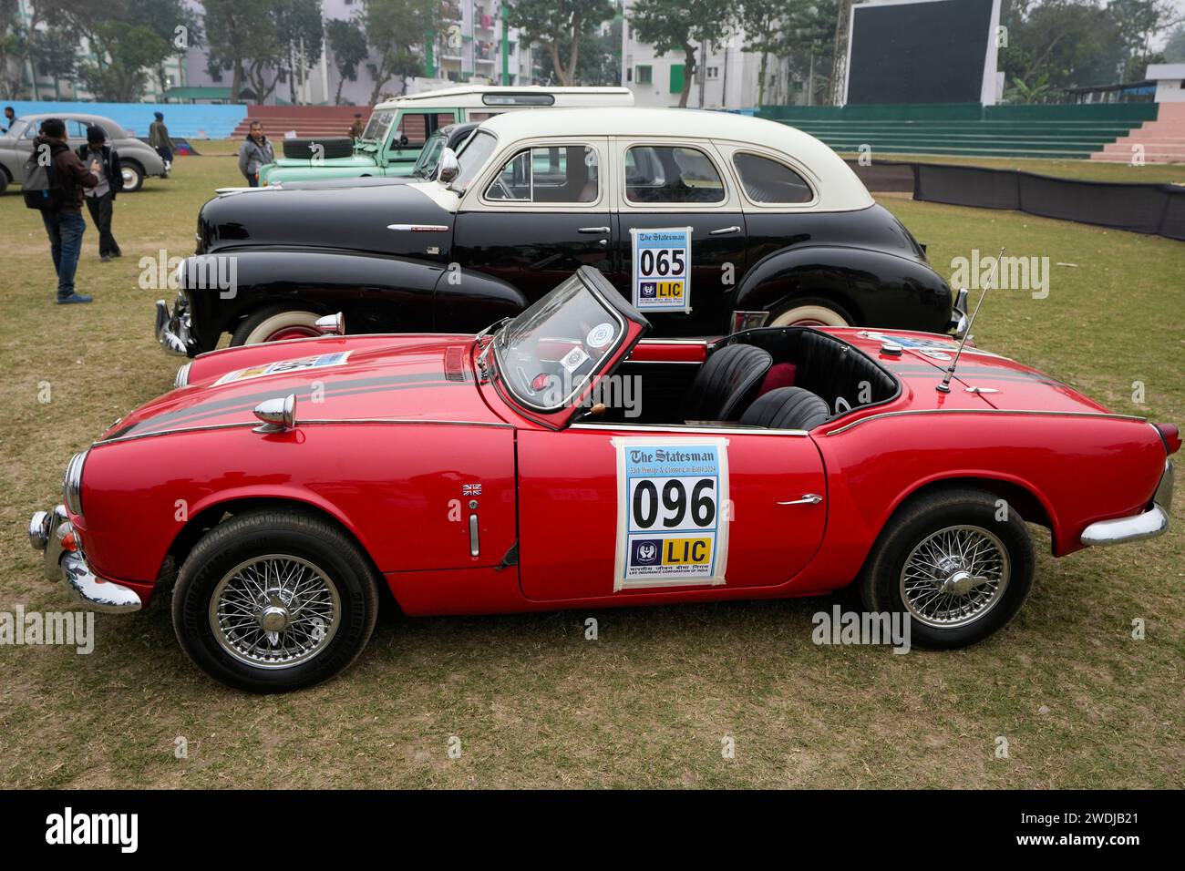 A 1963 Triumph Spit Fire is parked in front of a 1947 Chevrolet during ...