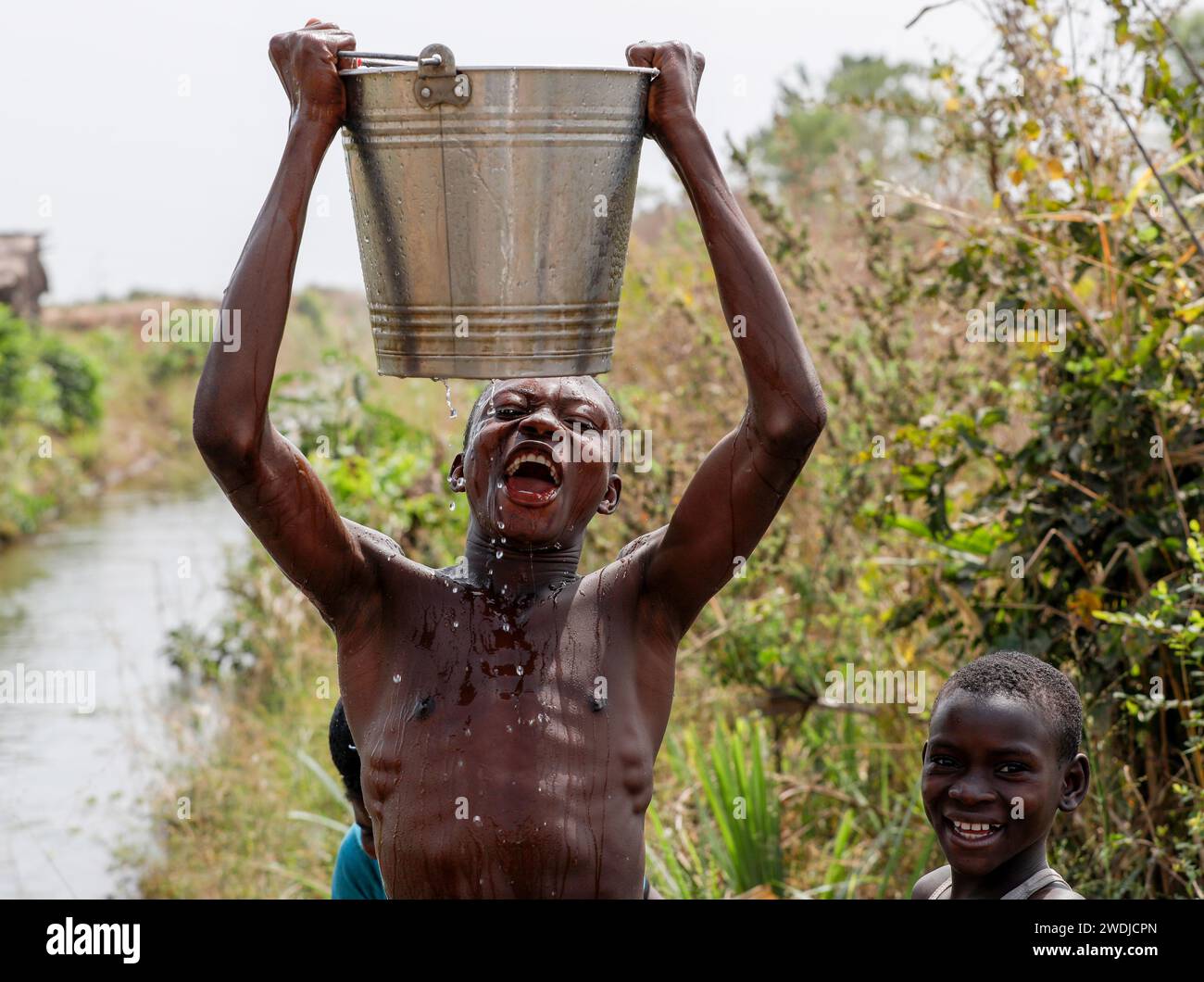Anie, Togo. 14th Jan, 2024. A villager fetches water from an irrigation ...