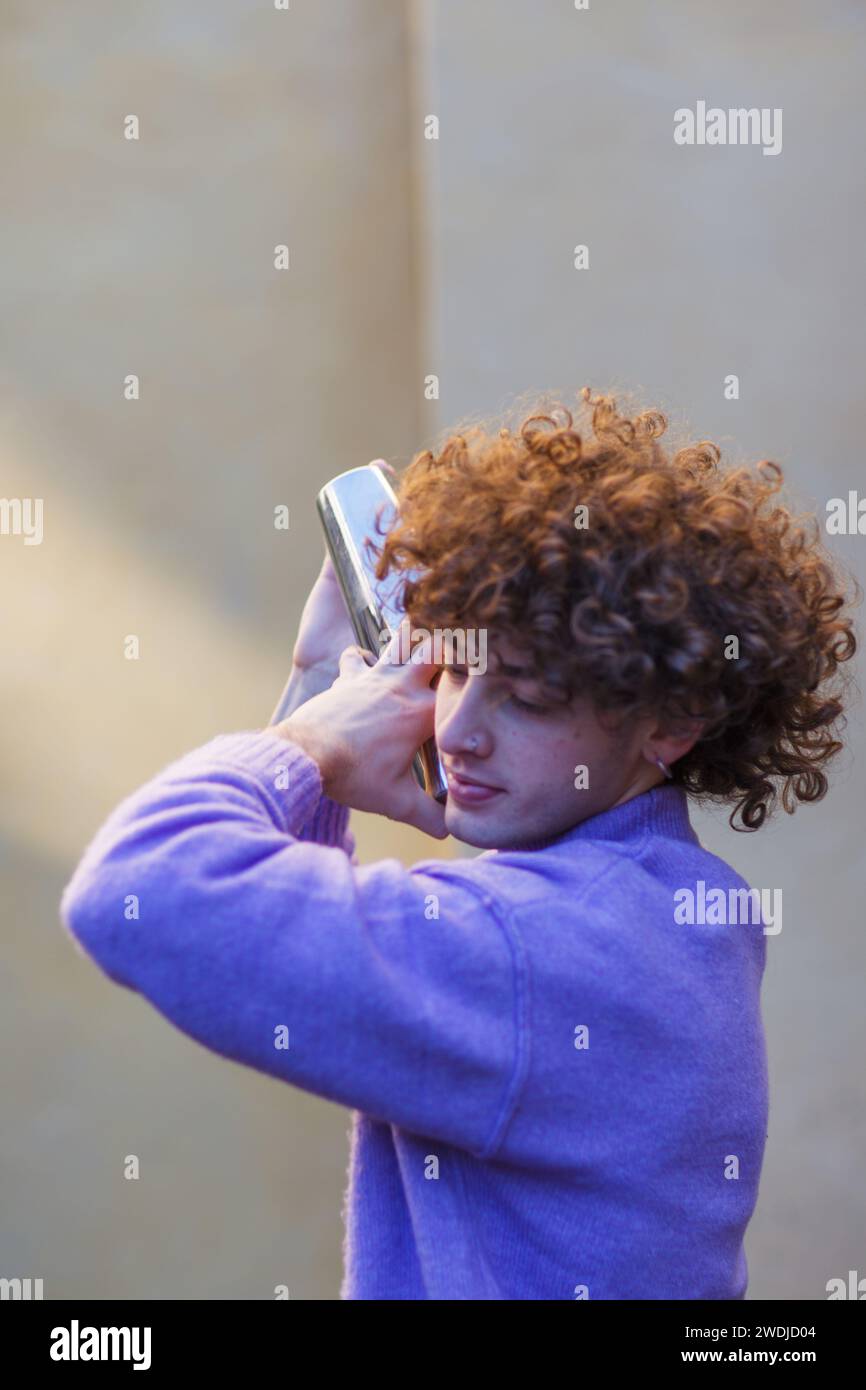 caucasian young cool red haired barista mixing a a cocktail in shaker ...