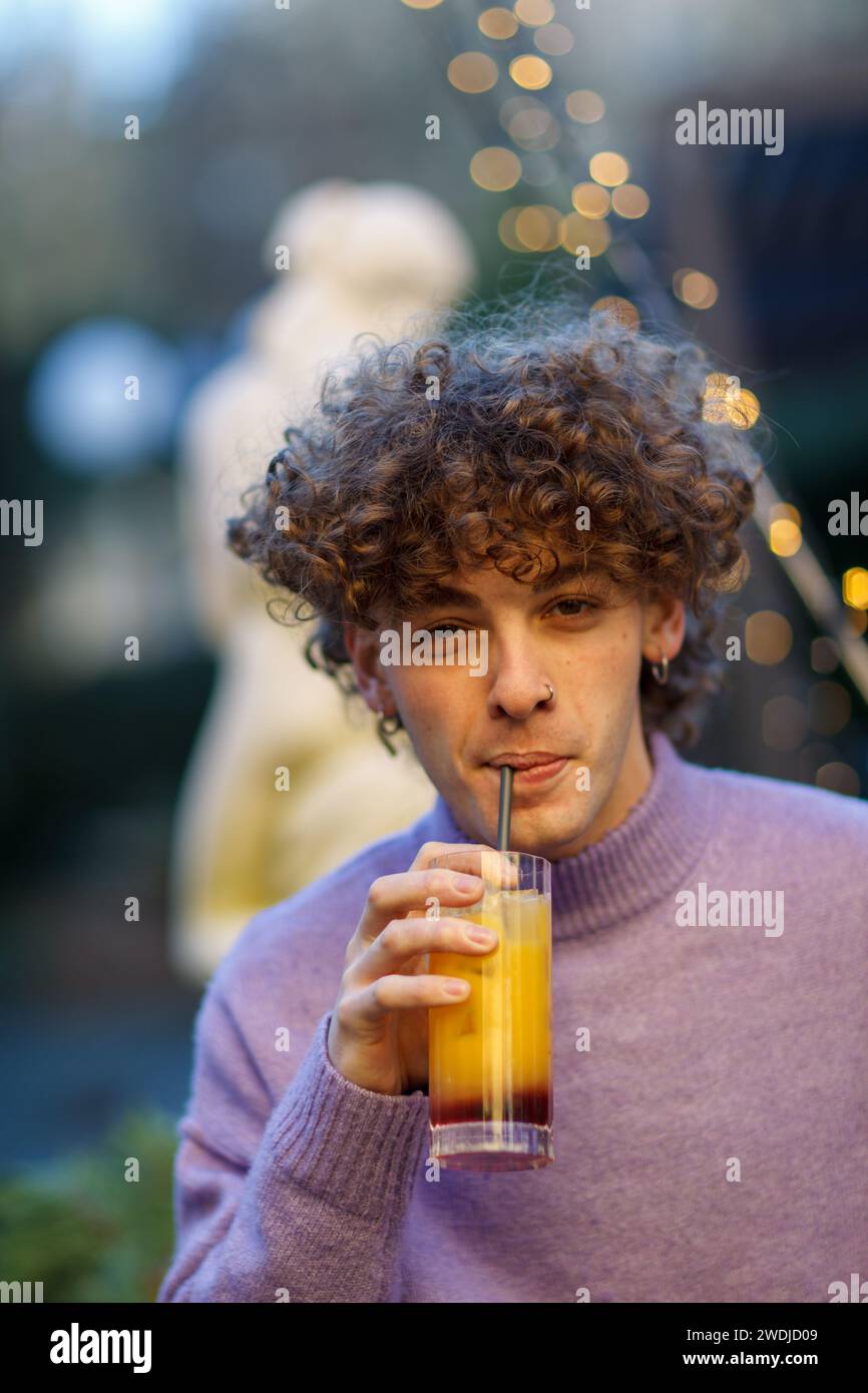caucasian young red head young man drink sip a tom collins cocktail ...