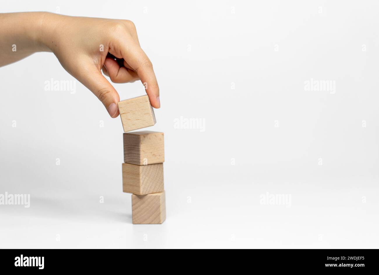 building wood blocks on white background; business or creative concept ...