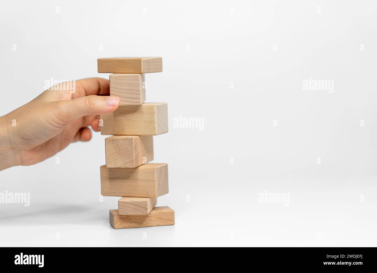 building wood blocks on white background; business or creative concept ...