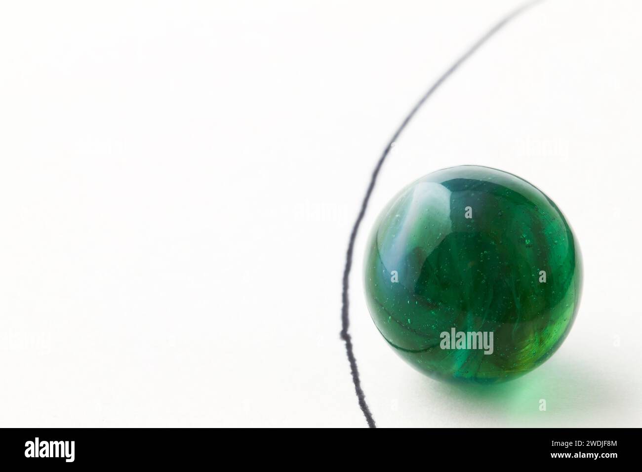 A green marble inside a drawn circle Stock Photo - Alamy