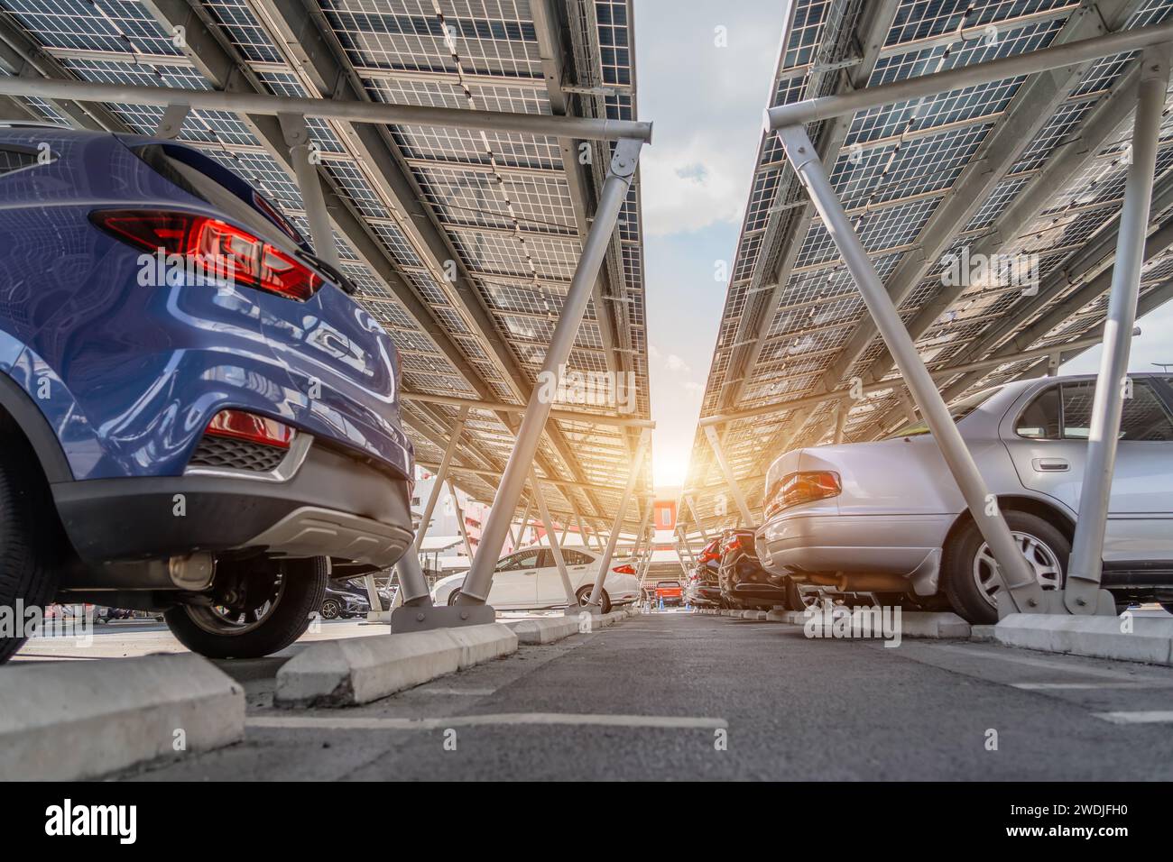 Solar panels installed over parking lot with parked cars for effective ...
