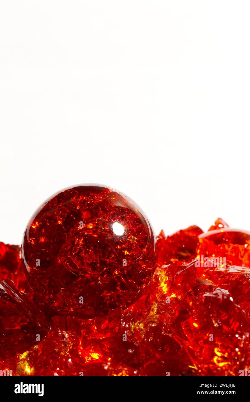 A red crackle glass marble on broken marbles Stock Photo - Alamy