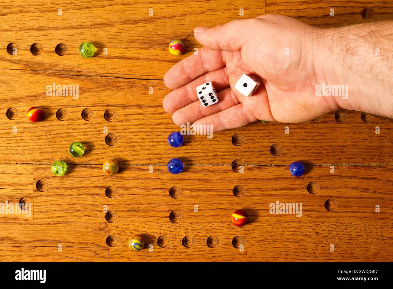 Hand with dice hi-res stock photography and images - Alamy