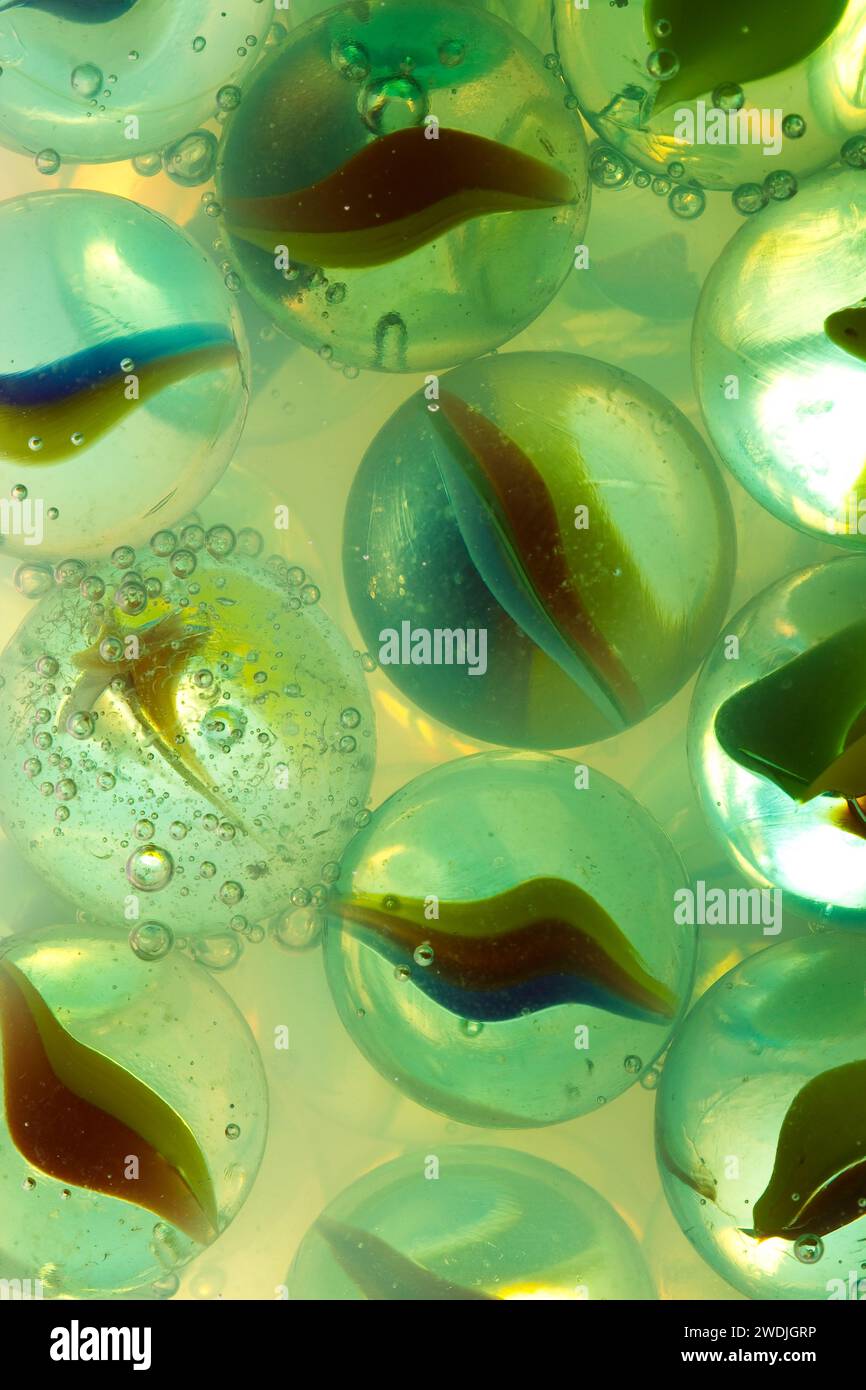 Cat Eye Marbles In Clear Soda Stock Photo - Alamy