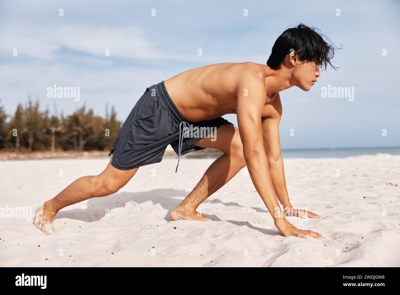 Active Asian Athlete Enjoying Sunset Run on Beach: Muscular Man ...