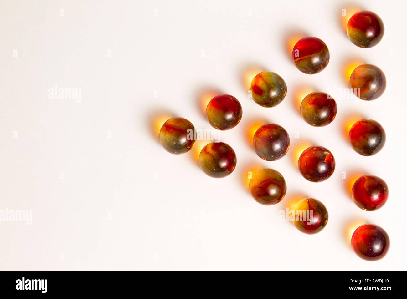 Red and Clear Glass Marbles In Triangle Formation Stock Photo - Alamy