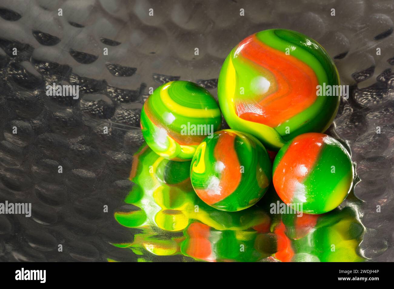 Colorful marbles in a metal bow Stock Photo - Alamy