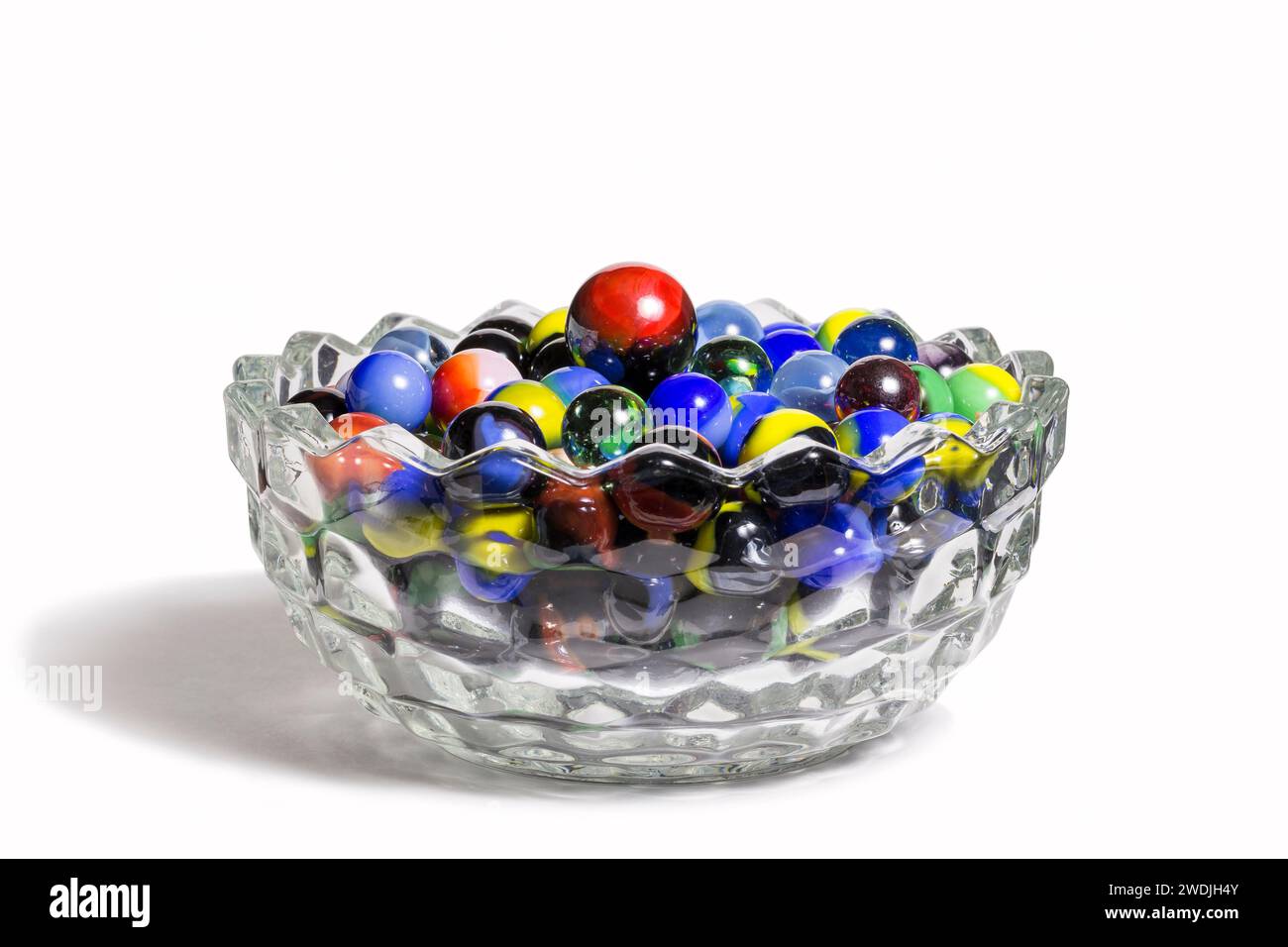 A colorful glass marble collection in a glass bowl Stock Photo - Alamy