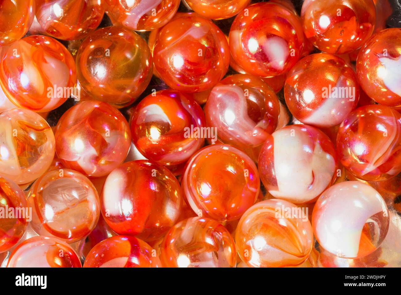 Orange, white, and transparent swirl glass marbles Stock Photo - Alamy