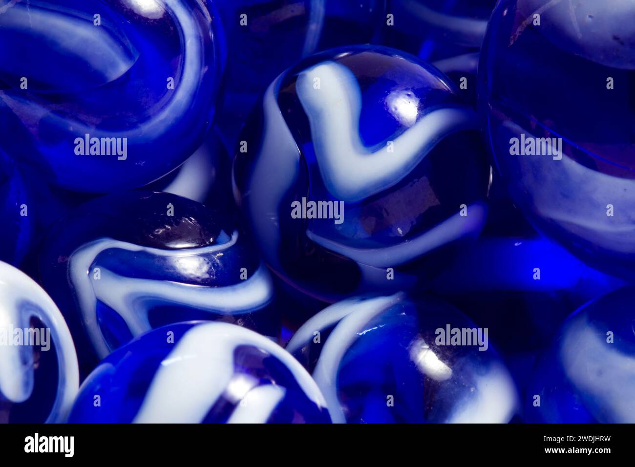 A collection of blue and white swirl glass marbles Stock Photo - Alamy