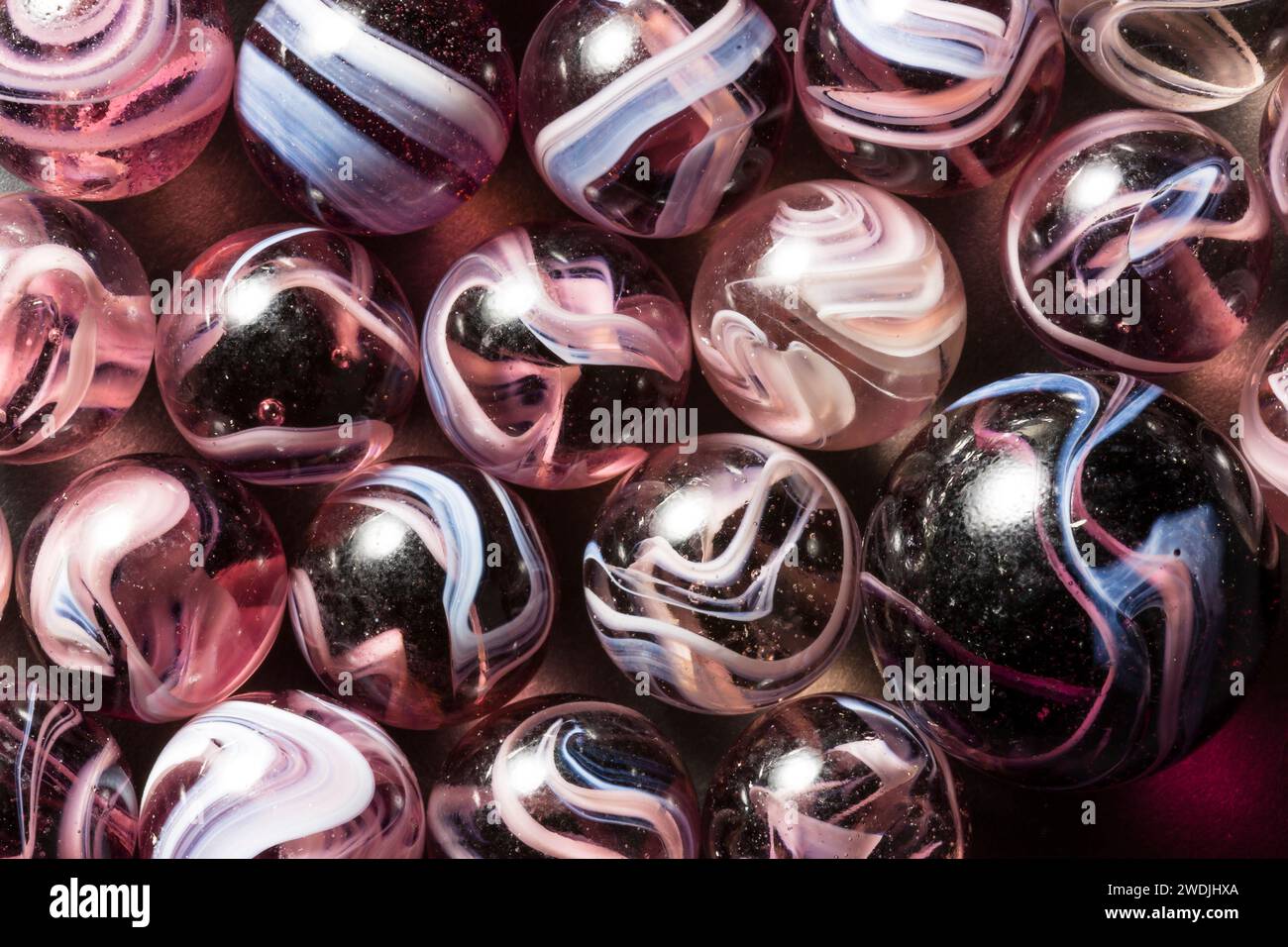 A collection of purple and white swirl glass marbles Stock Photo - Alamy