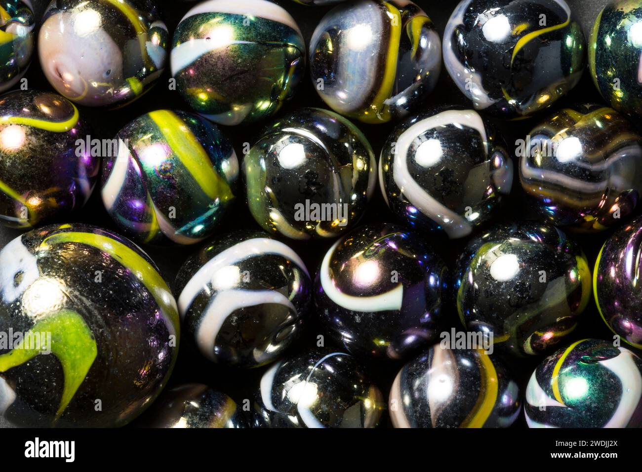 A collection of dark swirl glass marbles Stock Photo - Alamy
