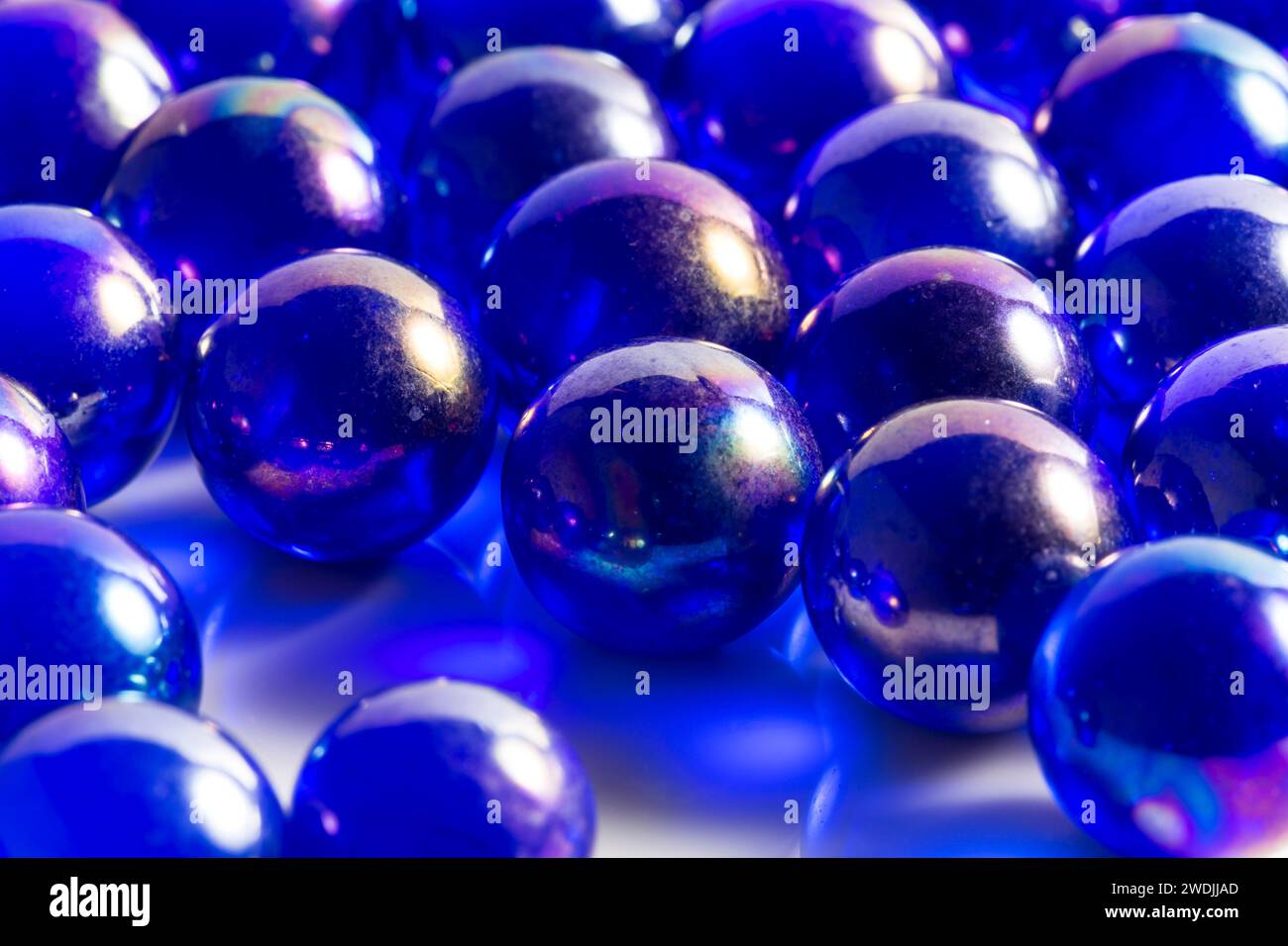 A collection of metallic blue glass marbles Stock Photo - Alamy