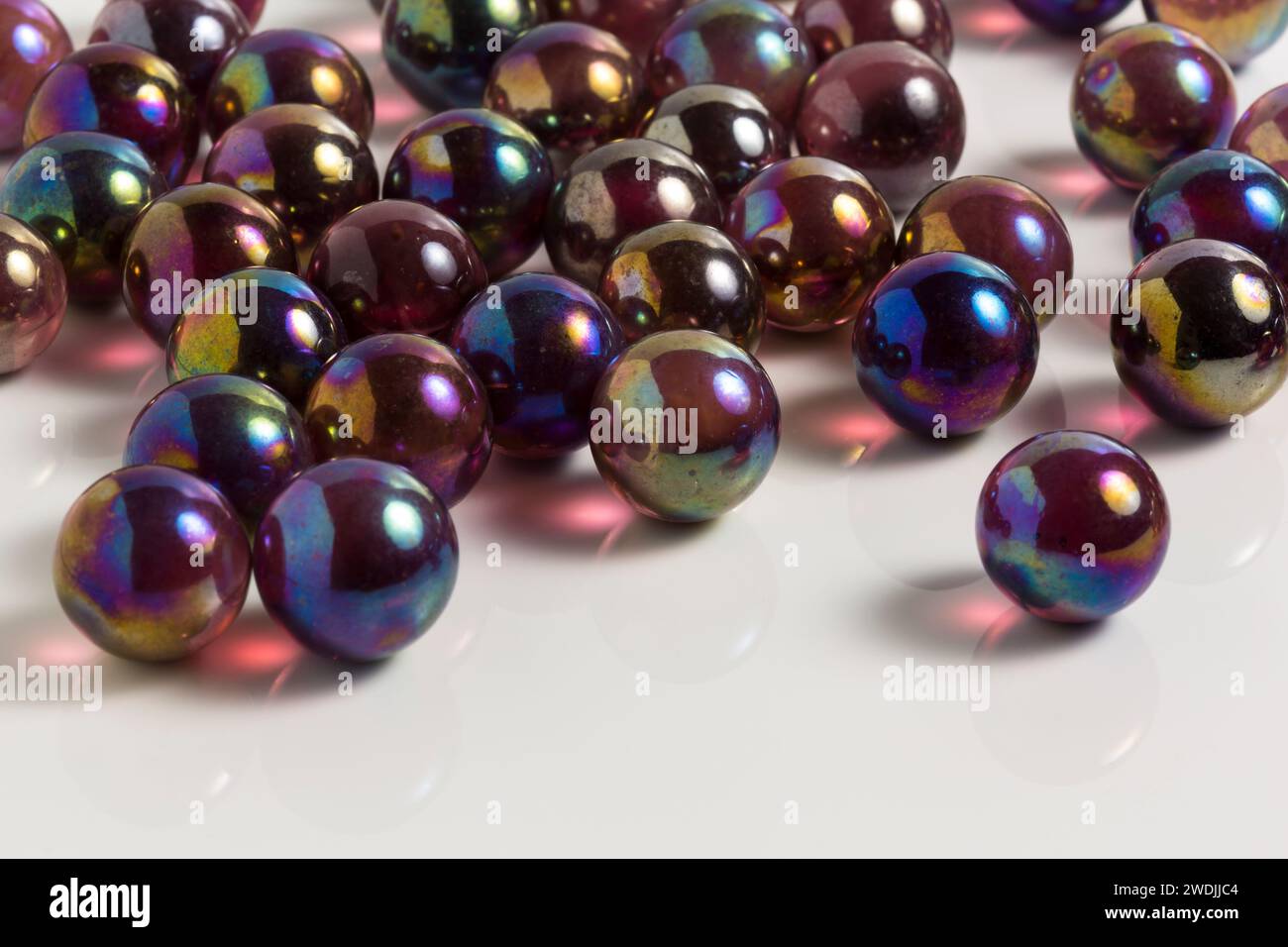 A collection of metallic purple glass marbles Stock Photo - Alamy