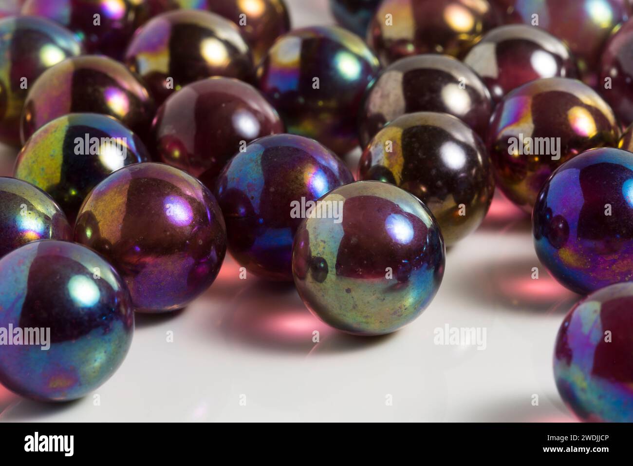 A collection of metallic purple glass marbles Stock Photo - Alamy