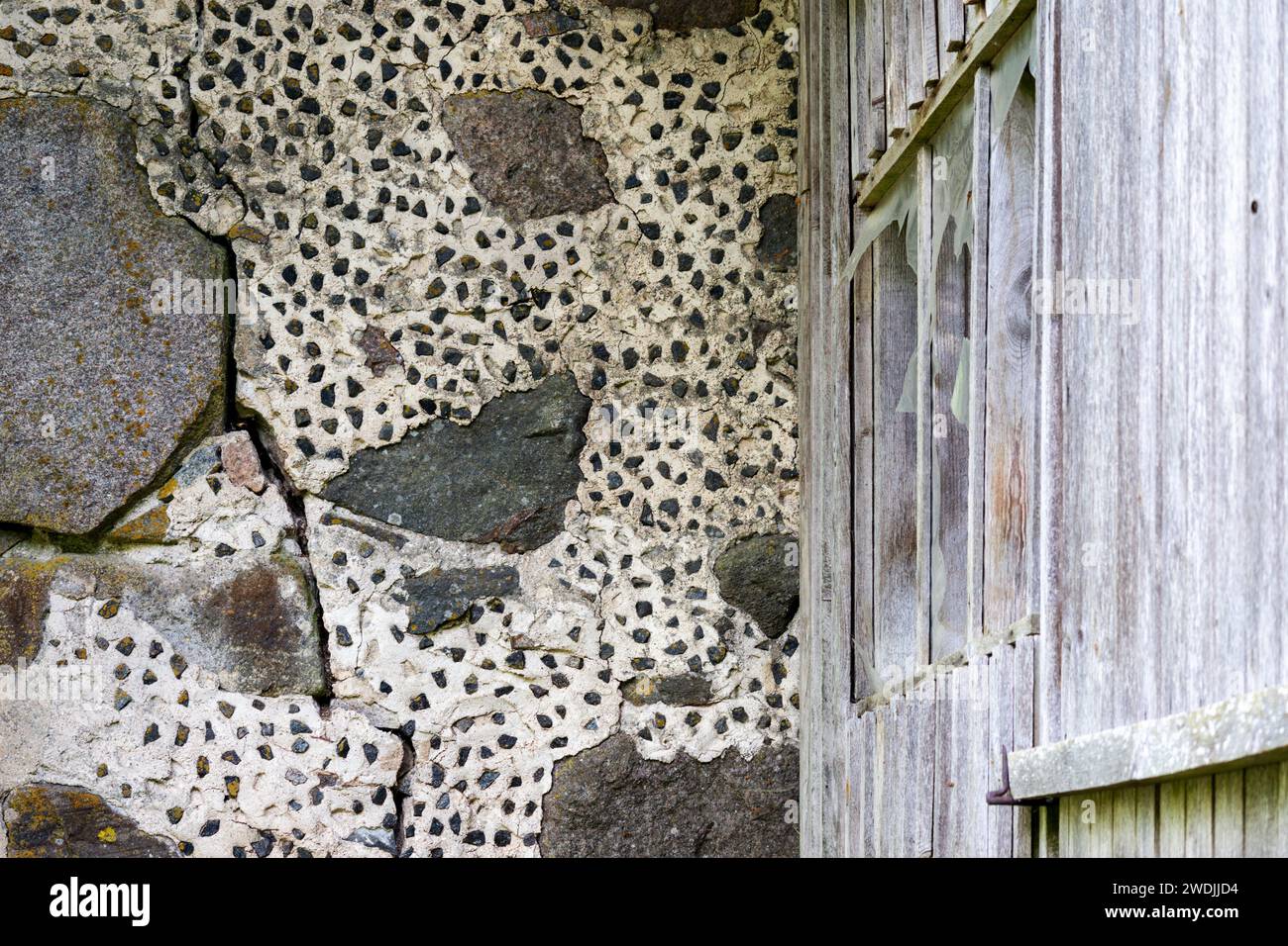 stone wall of a boulder building with small embedded stones Stock Photo ...
