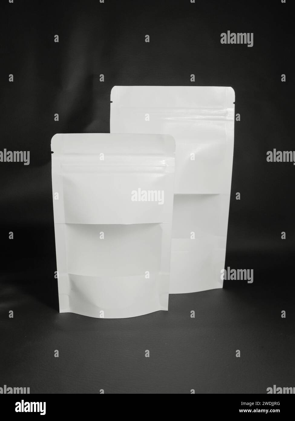 Blank white plastic bag isolated on black background Stock Photo - Alamy